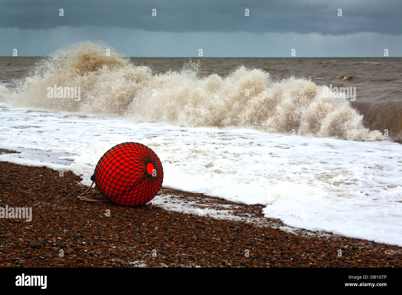 A bouy washed up on the beach in rough sea Stock Photo - Alamy