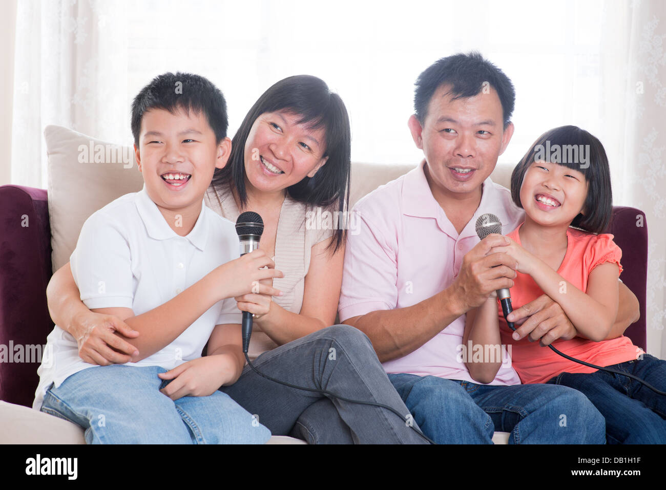 Asian family singing karaoke Stock Photo - Alamy