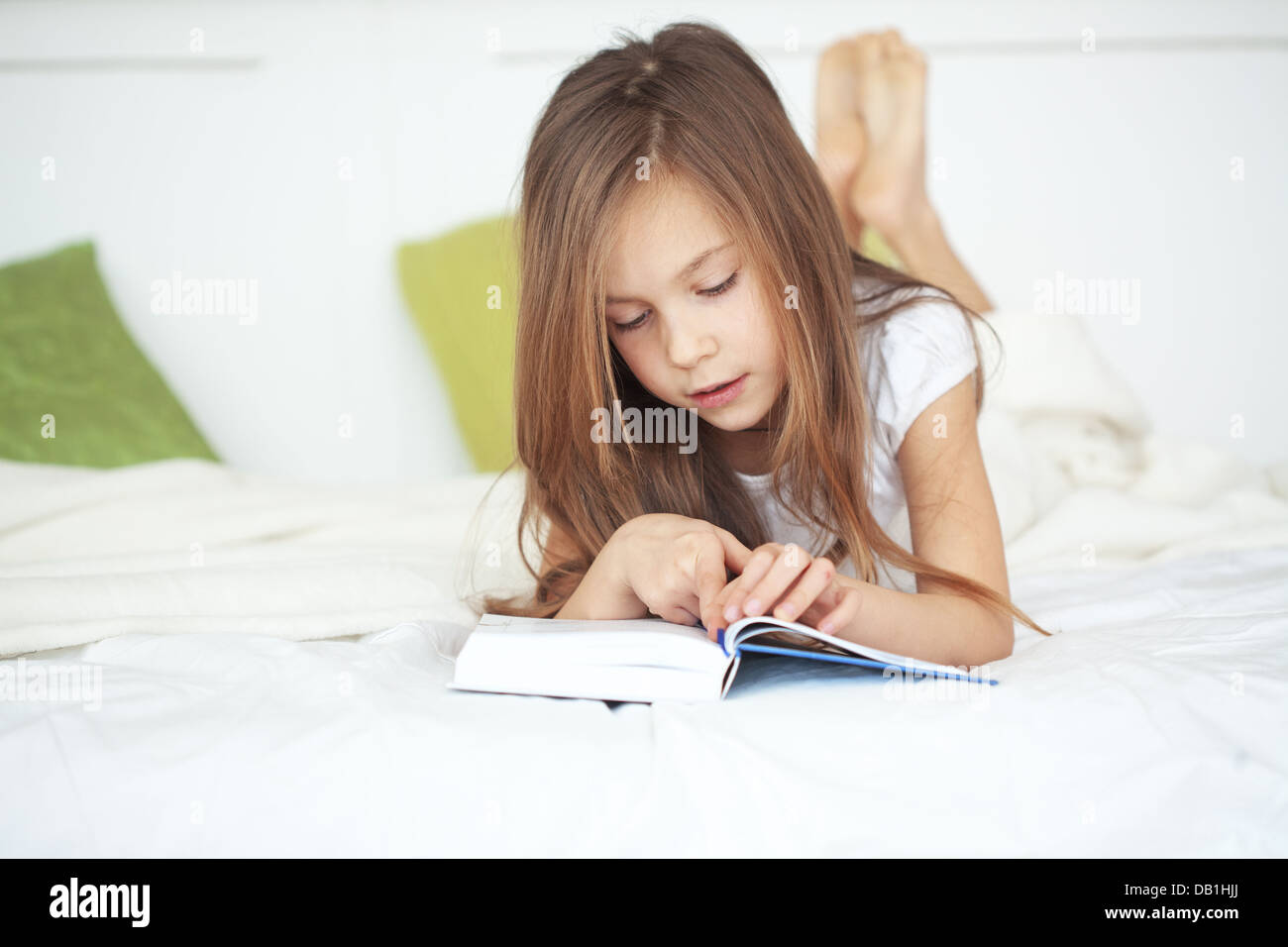 Child reading a book Stock Photo - Alamy