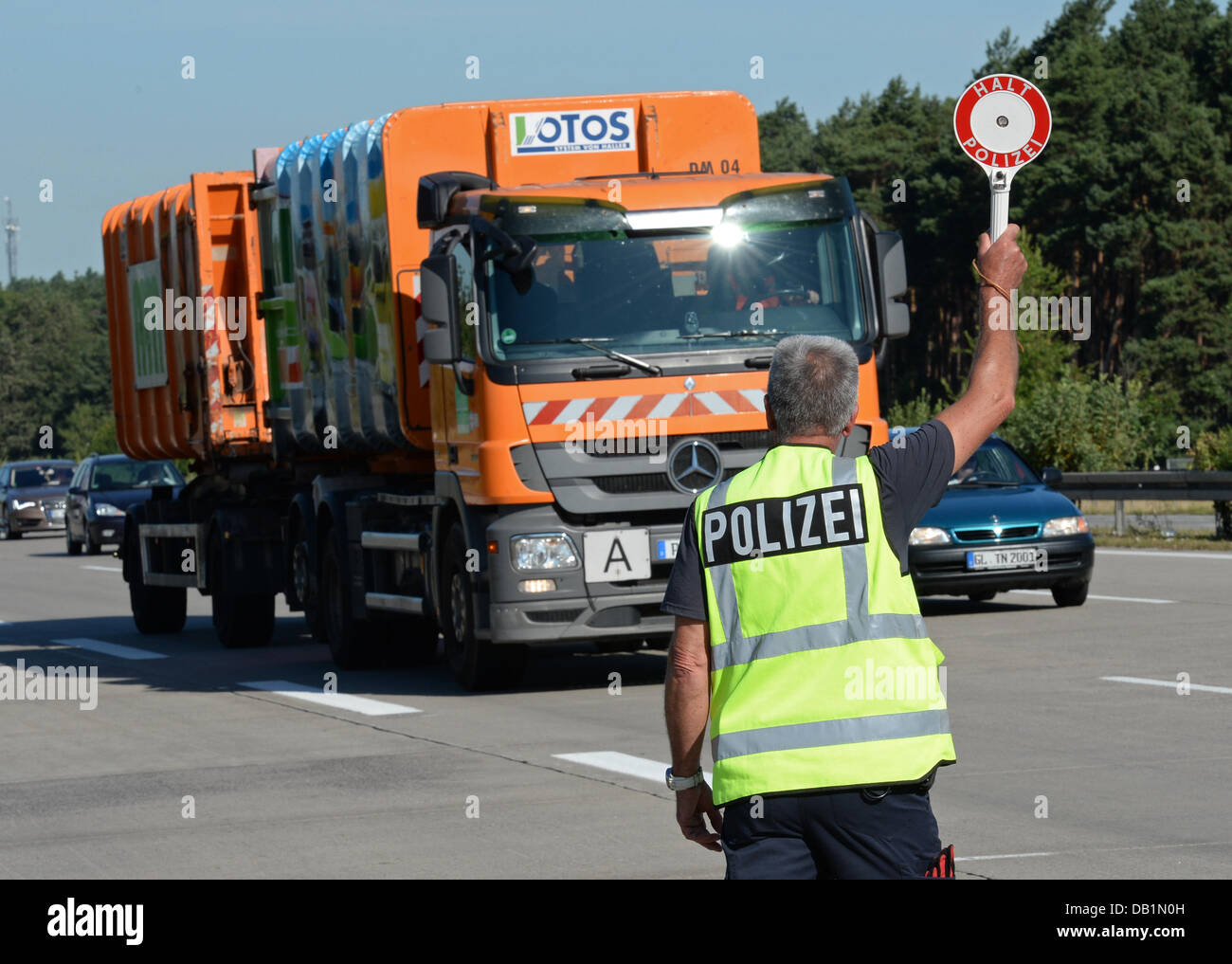 A police officer stops a truck at the A2 motorway near Brandenburg ...