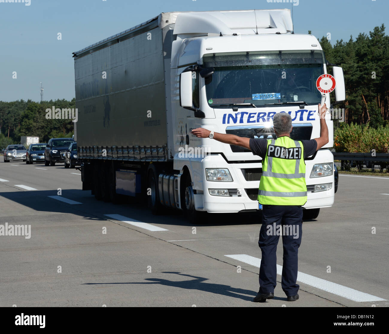 A police officer stops a truck at the A2 motorway near Brandenburg ...