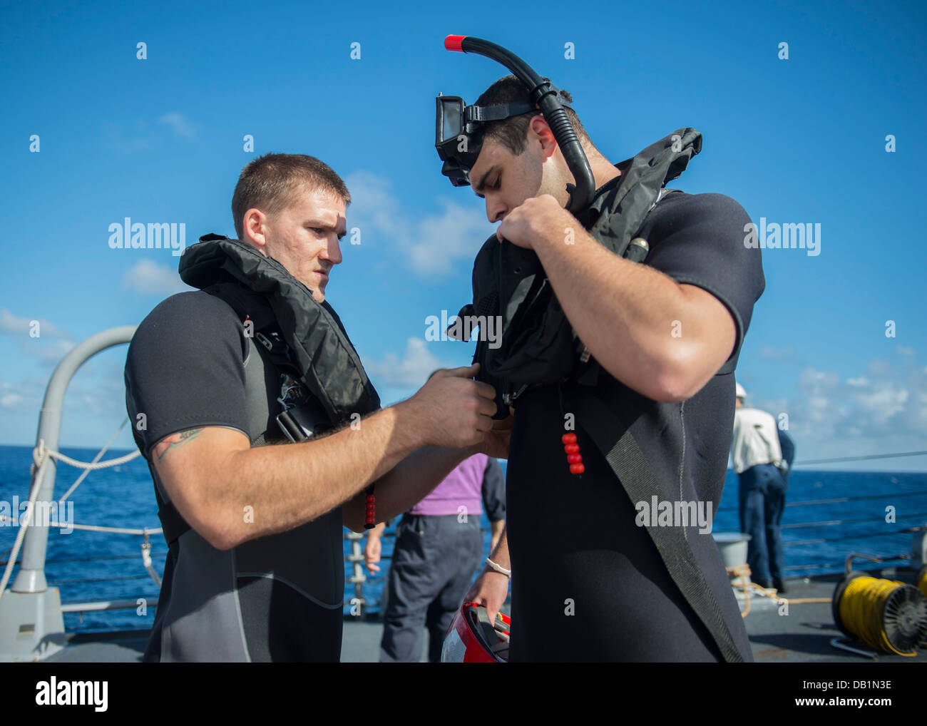 Search and rescue swimmer Quartermaster 2nd Class Riley Knox, left ...