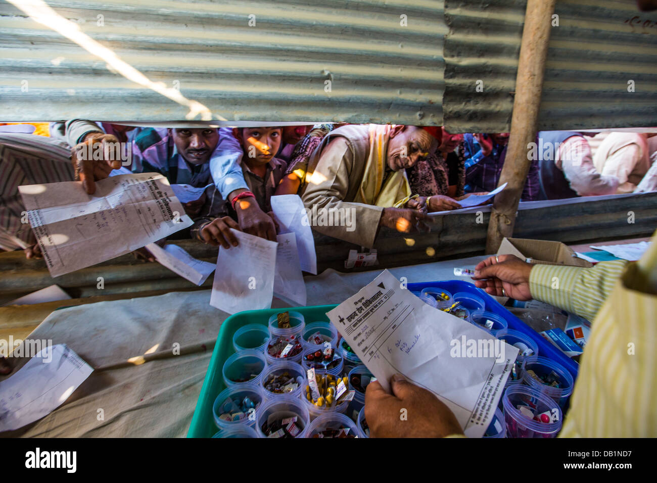 People collect medication at a field dispensary at the Kumbh Mela in ...