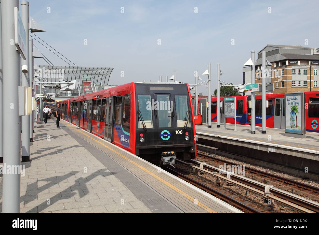 A London Docklands Light Railway train departs from Poplar Station ...