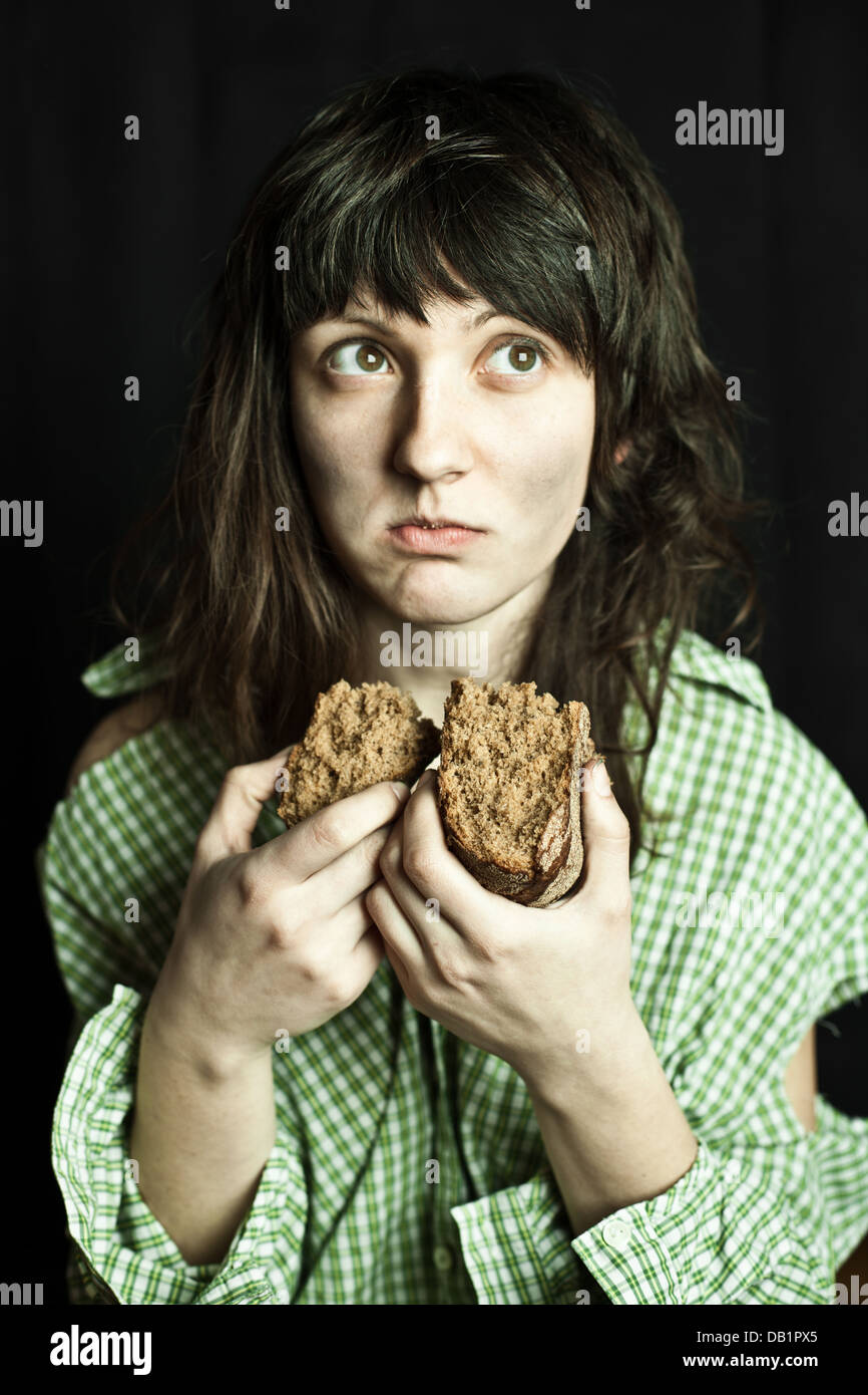 beggar woman eating bread Stock Photo - Alamy