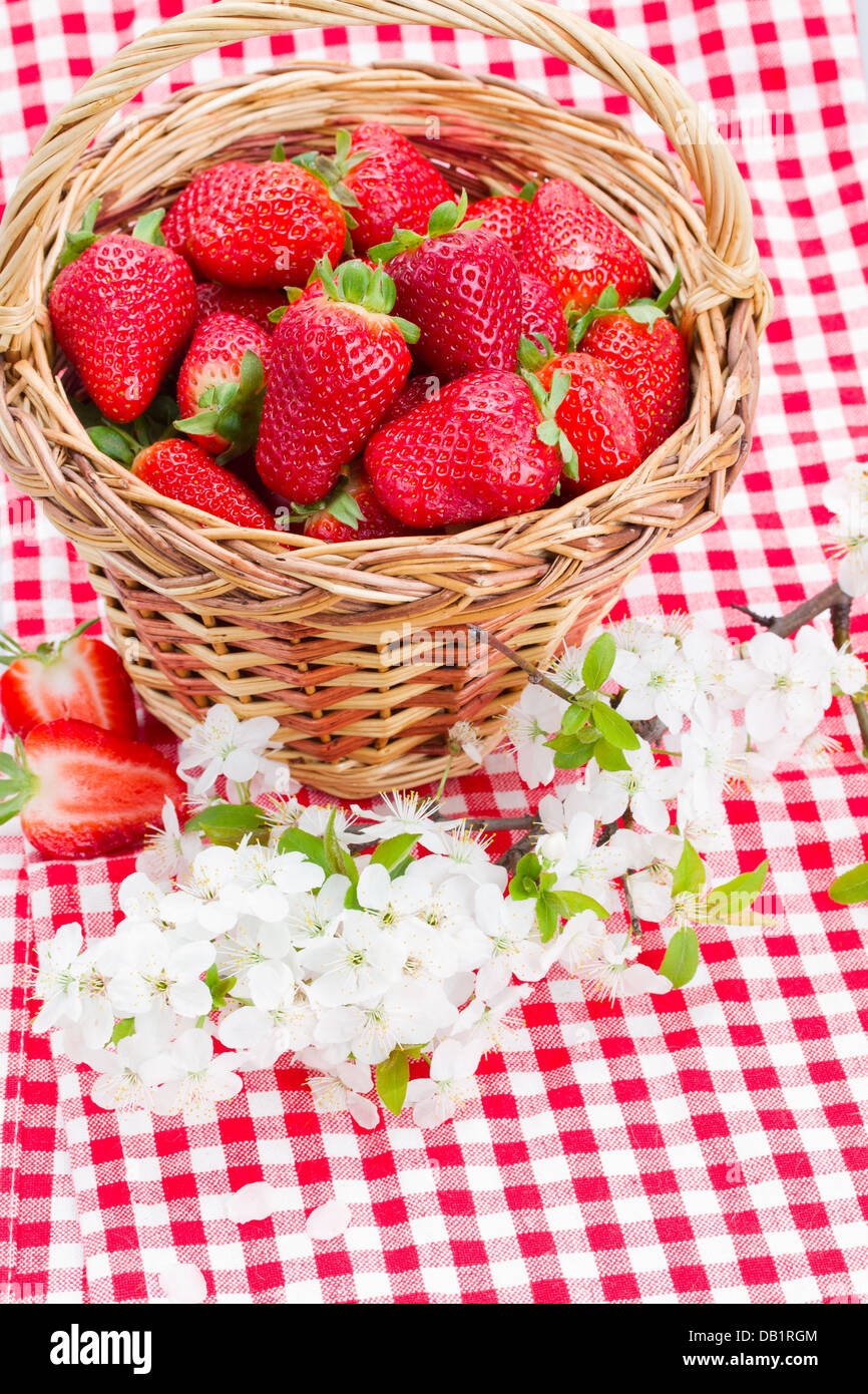 strawberry in basket and spring flowers Stock Photo - Alamy