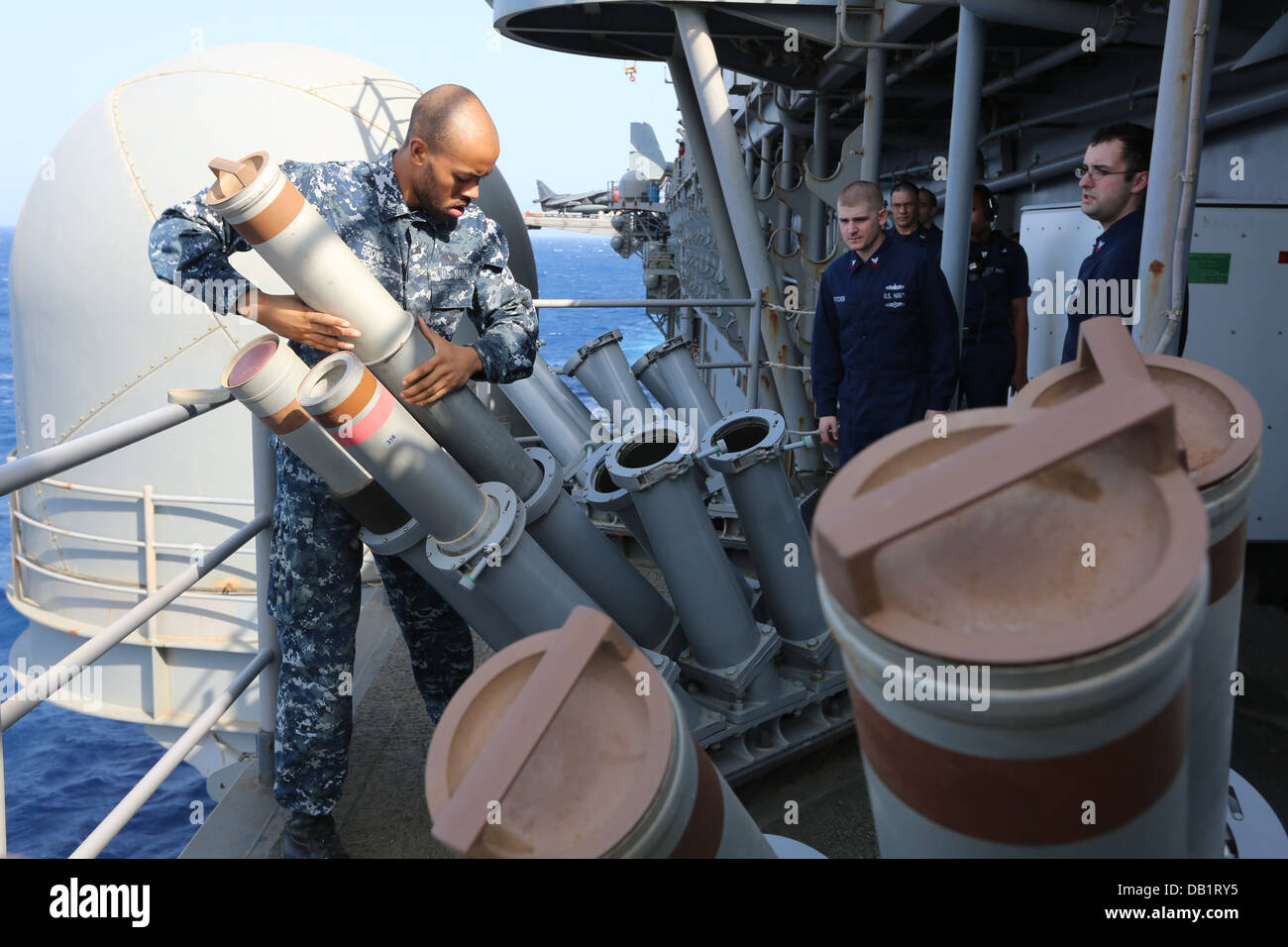 Cryptologic Technician (Collection) 3rd Class Jamal Brown loads a round ...
