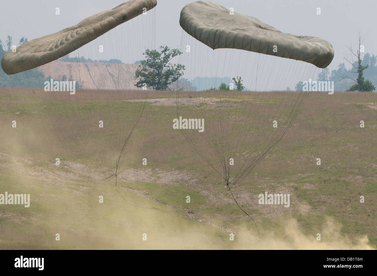 A heavy load dropped from a C-130 hits the drop zone of Camp Branch in ...