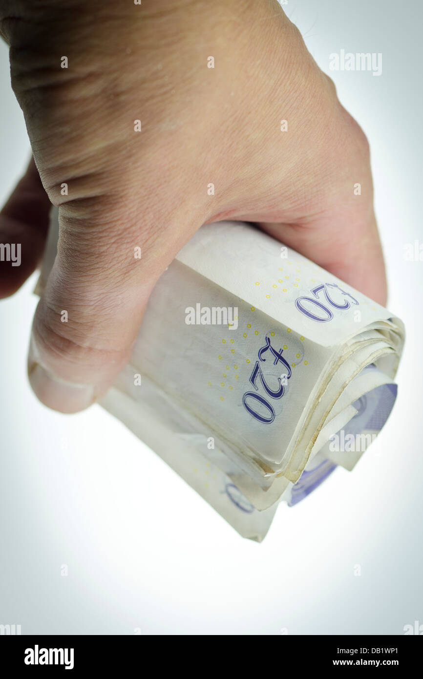 Hand Holding Rolled Up Twenty Pound Notes Stock Photo - Alamy