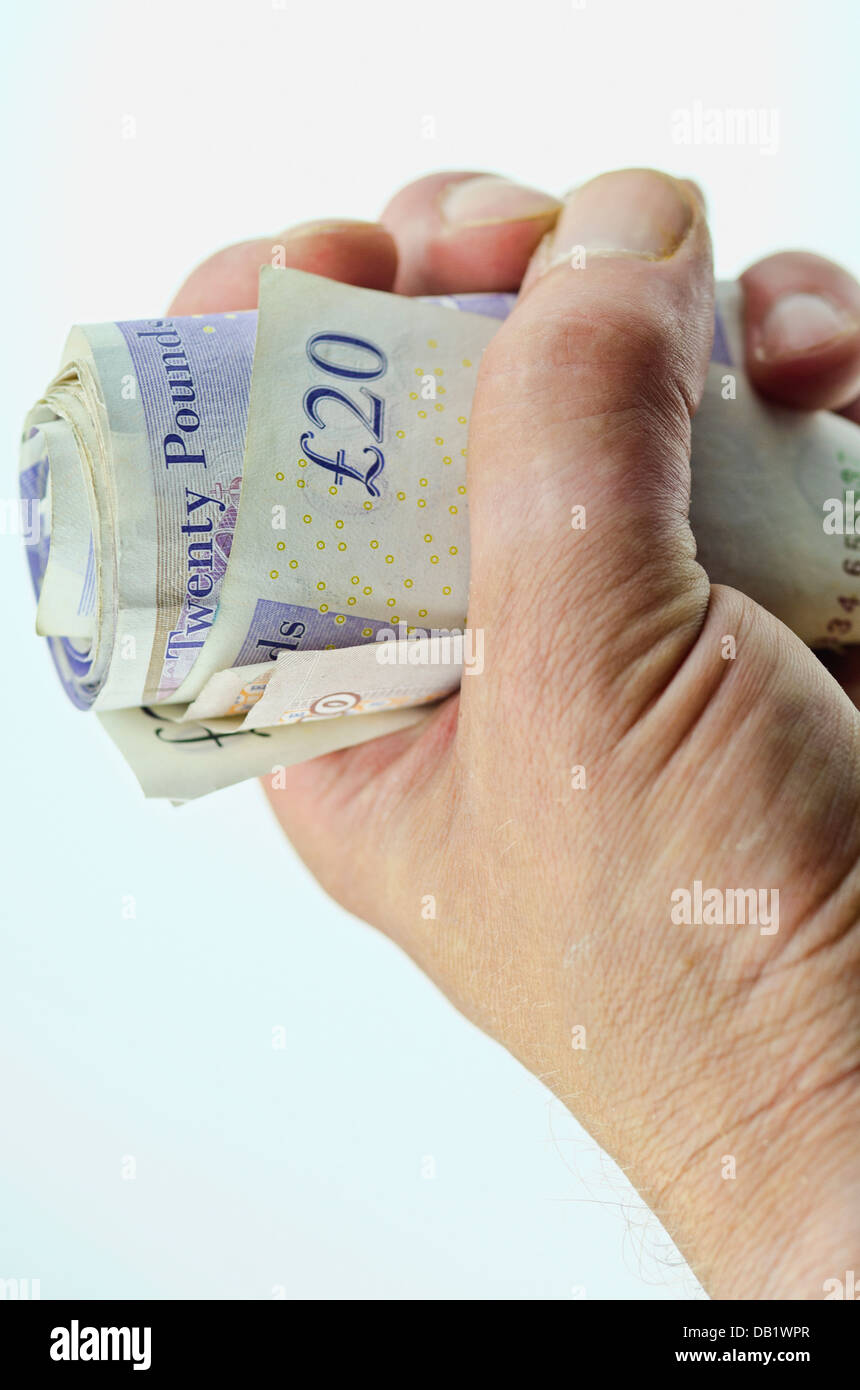 Hand Holding Rolled Up Twenty Pound Notes Stock Photo - Alamy