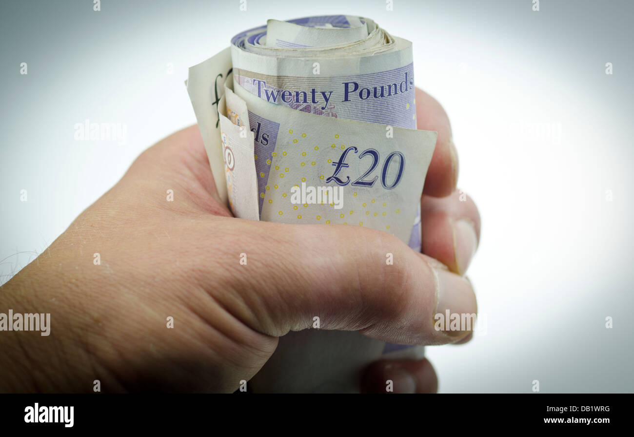 Hand Holding Rolled Up Twenty Pound Notes Stock Photo - Alamy