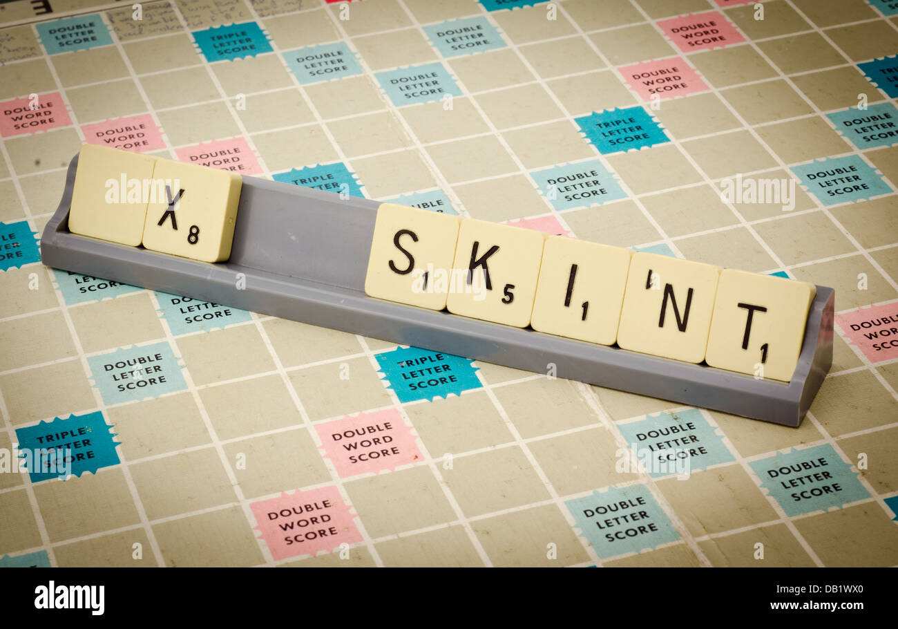 Skint spelled out with Scrabble Letters Stock Photo - Alamy