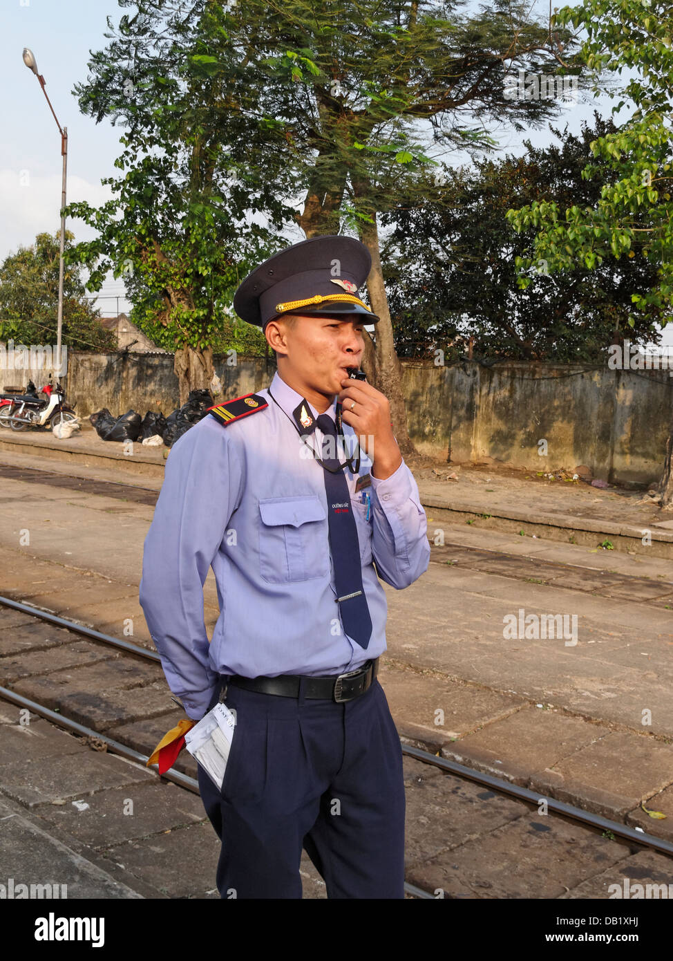 Guard blowing his whistle at Dieu Tri railway station, Vietnam Stock ...