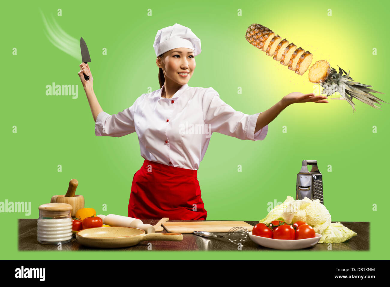Asian female chef cuts pineapple Stock Photo - Alamy