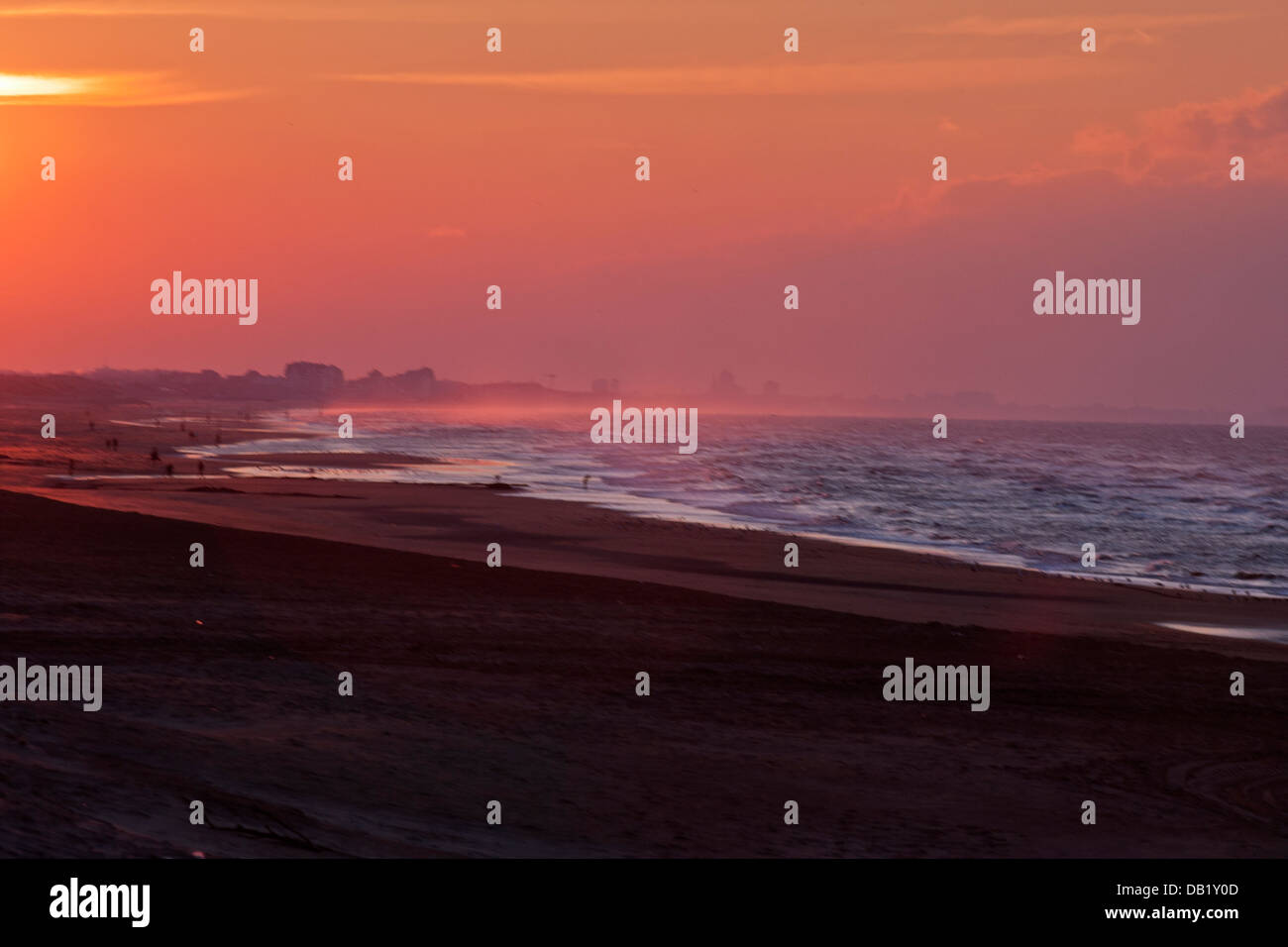 Sunset over Coxyde beach with Dunkirk in a foggy background Stock Photo ...