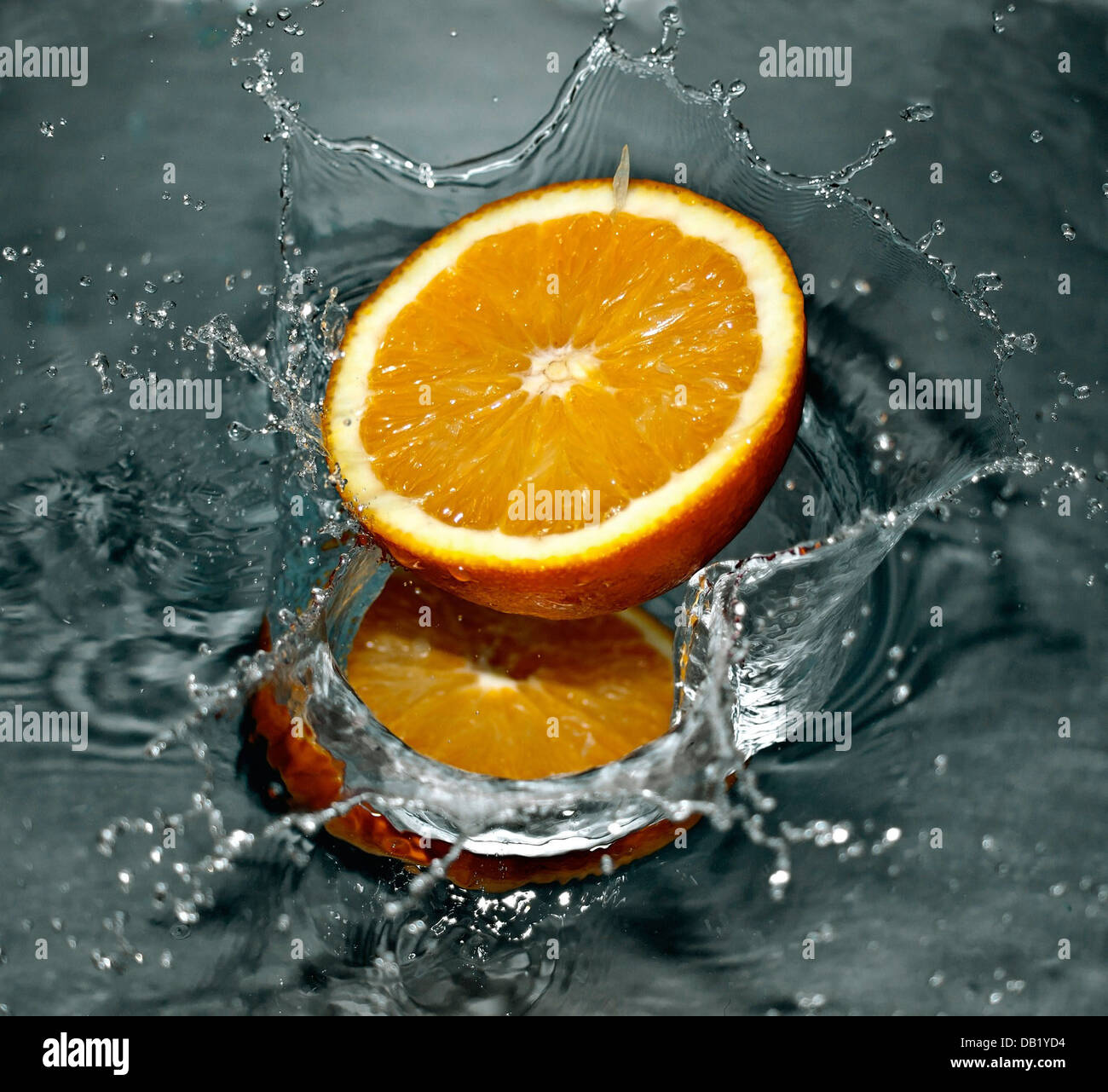 This image captures the dynamic and vibrant splash of orange water. The ...