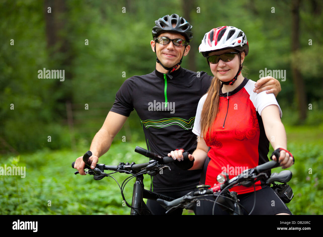 Young man and woman having bike ride in nature Stock Photo - Alamy