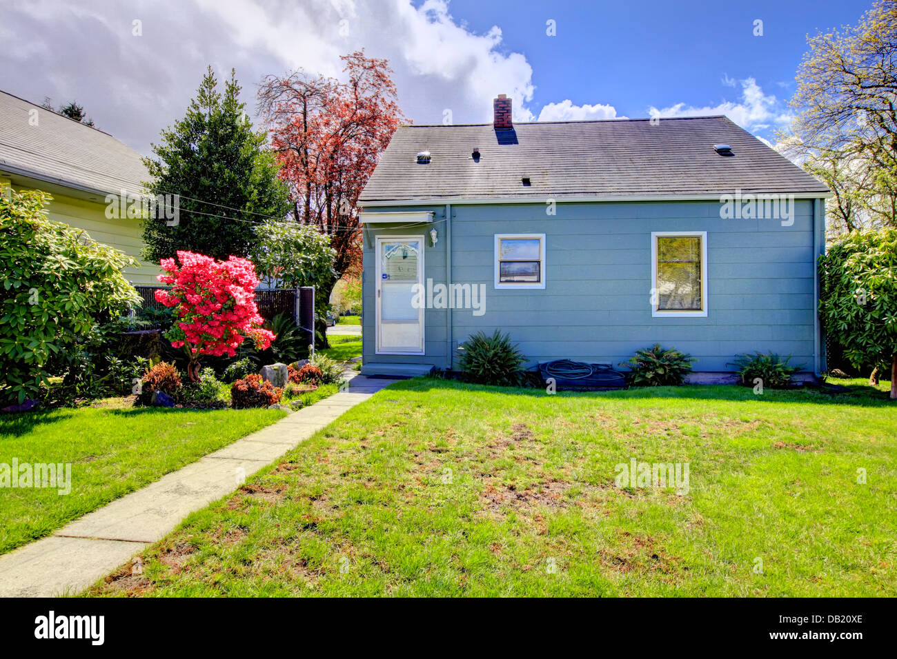 Blue small house with spring landscape from backyard Stock Photo - Alamy