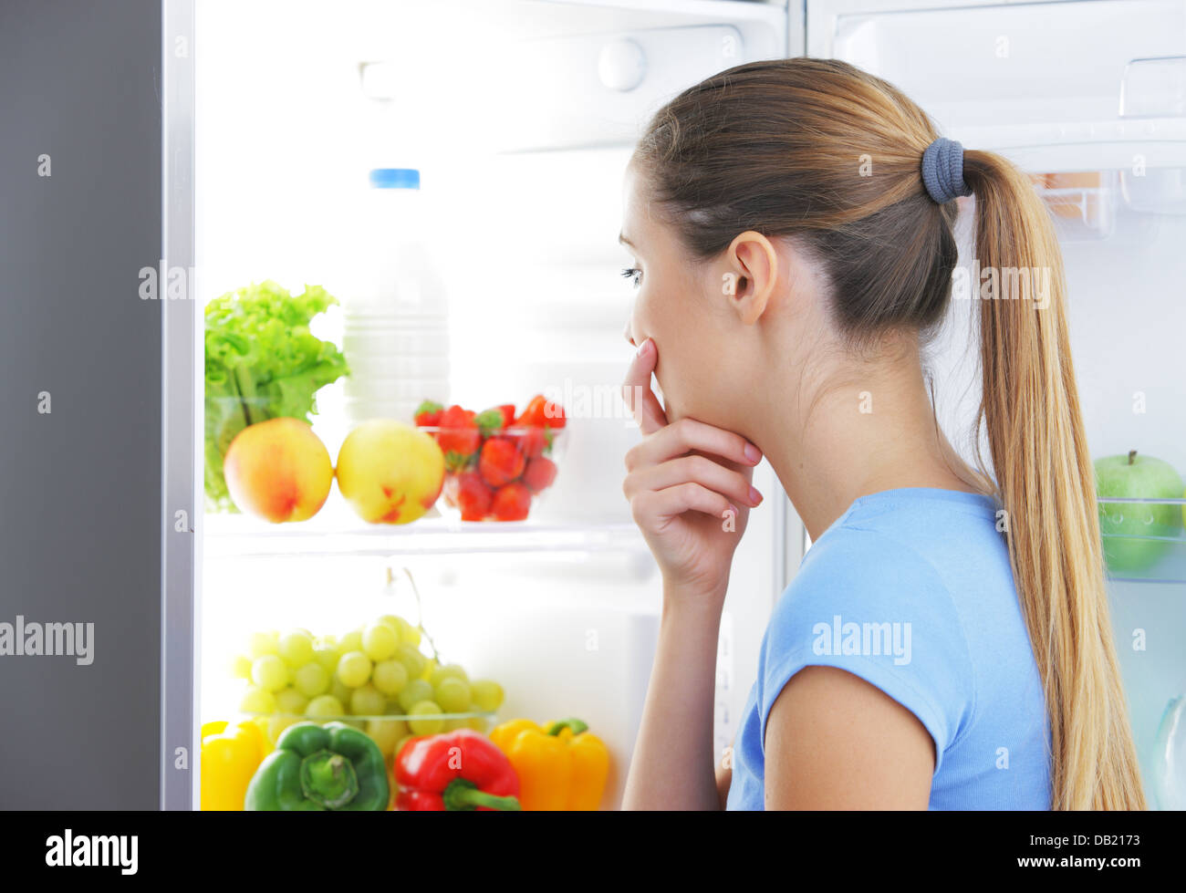 Young woman choosing food Stock Photo - Alamy