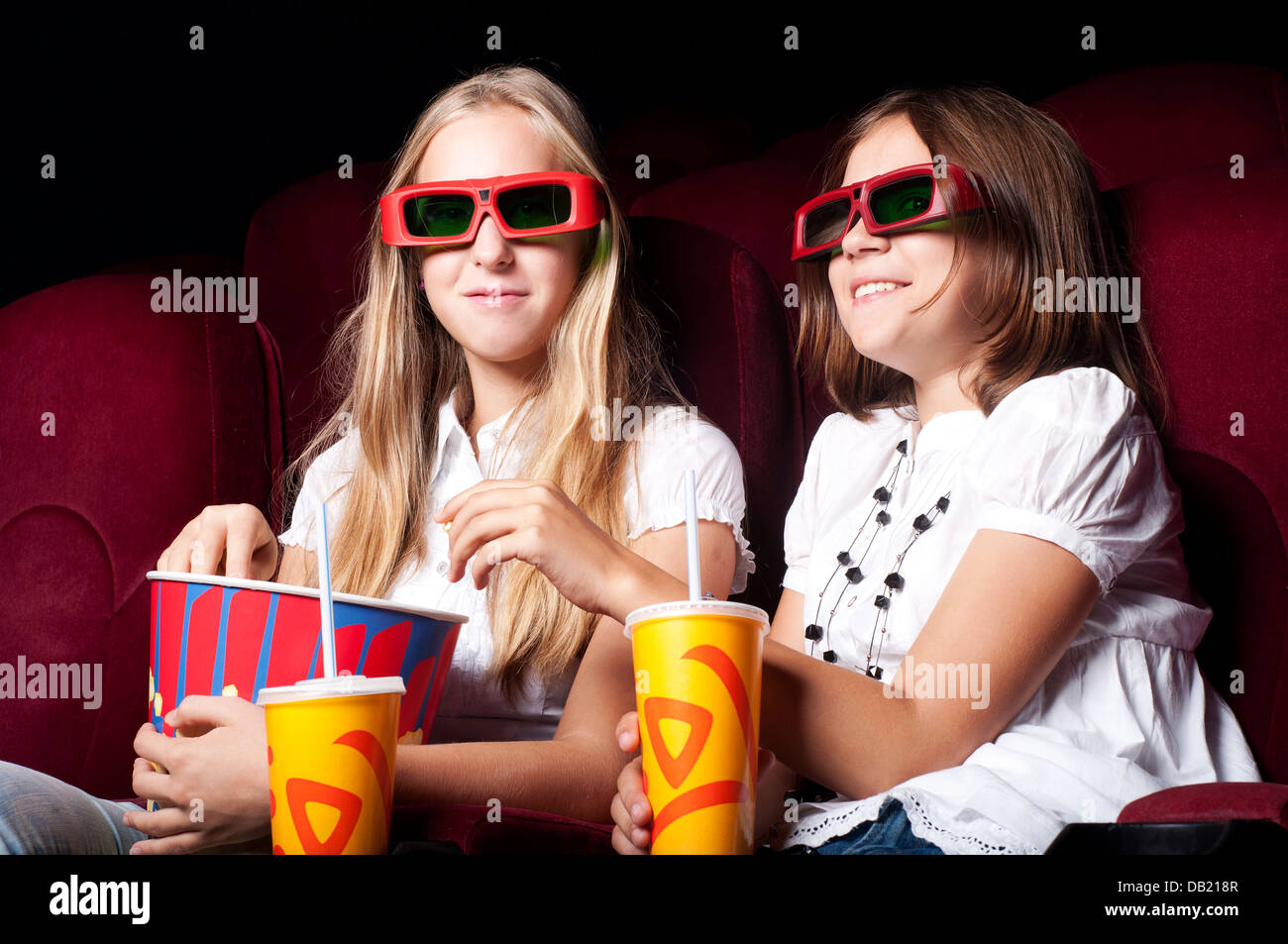 two beautiful girls watching a movie at the cinema Stock Photo - Alamy