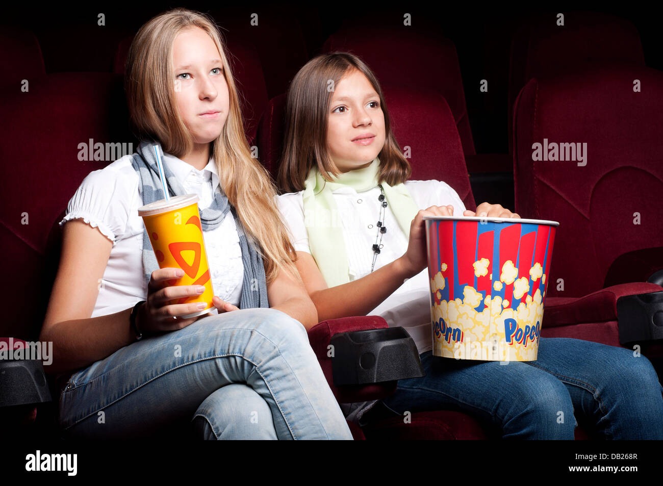 two beautiful girls watching a movie at the cinema Stock Photo - Alamy