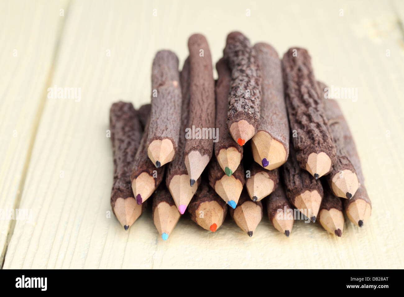 stack of tree trunk pencils on wooden table Stock Photo - Alamy
