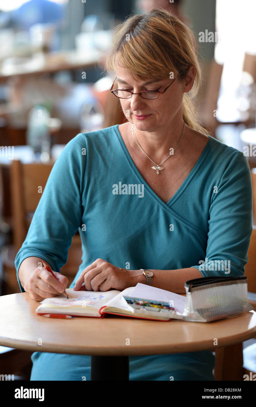 Artist Anja Rieger draws a scene in a cafe at Checkpoint Charlie in ...