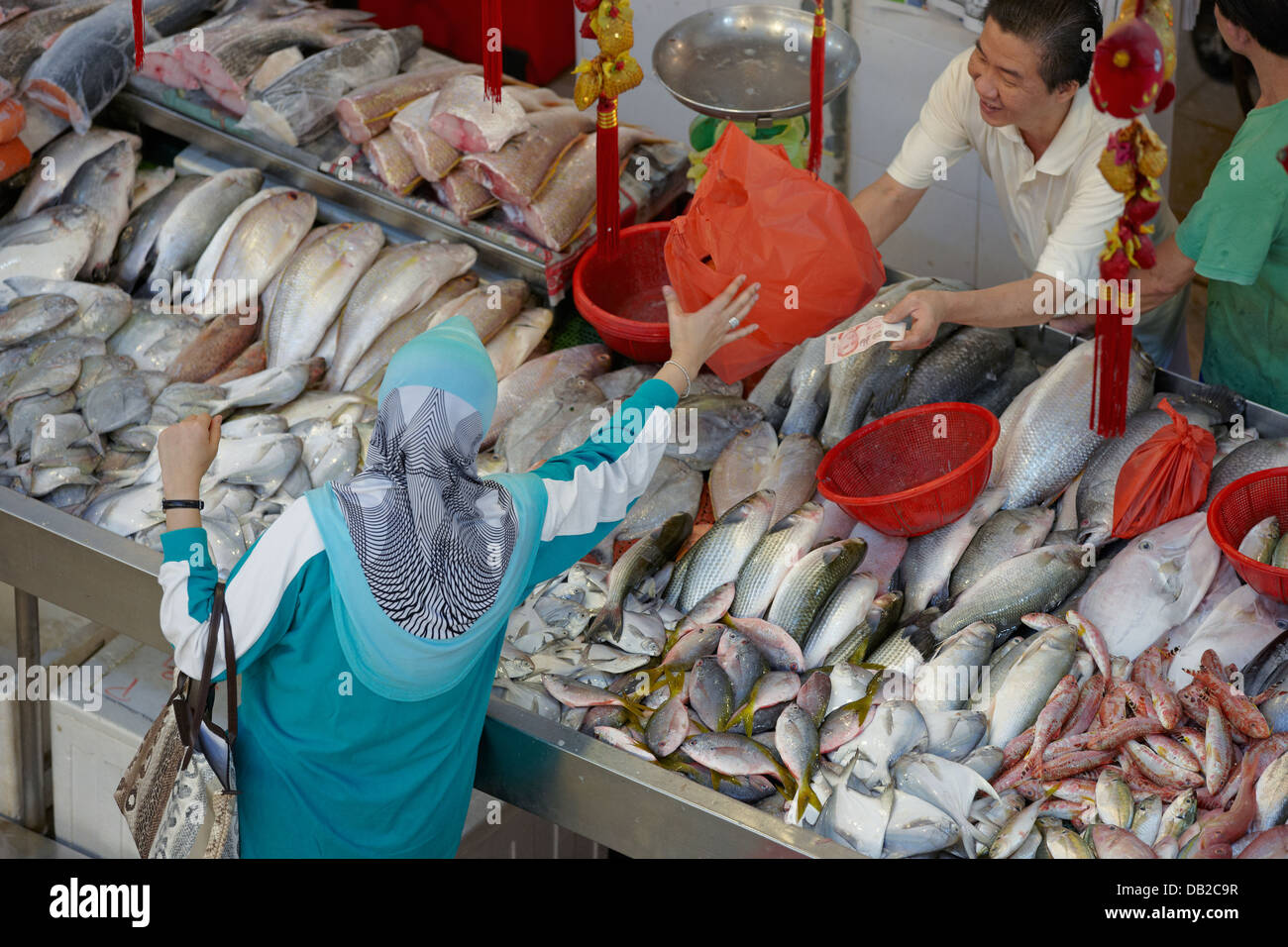 Local woman buying fresh fish at Tekka Market. Little India, Singapore ...