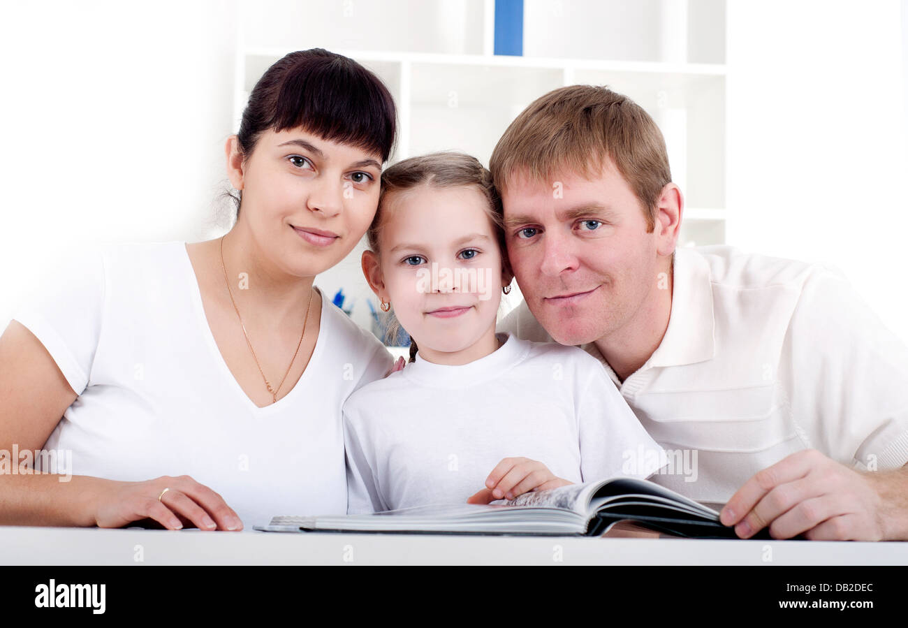 Family reading a book together Stock Photo - Alamy