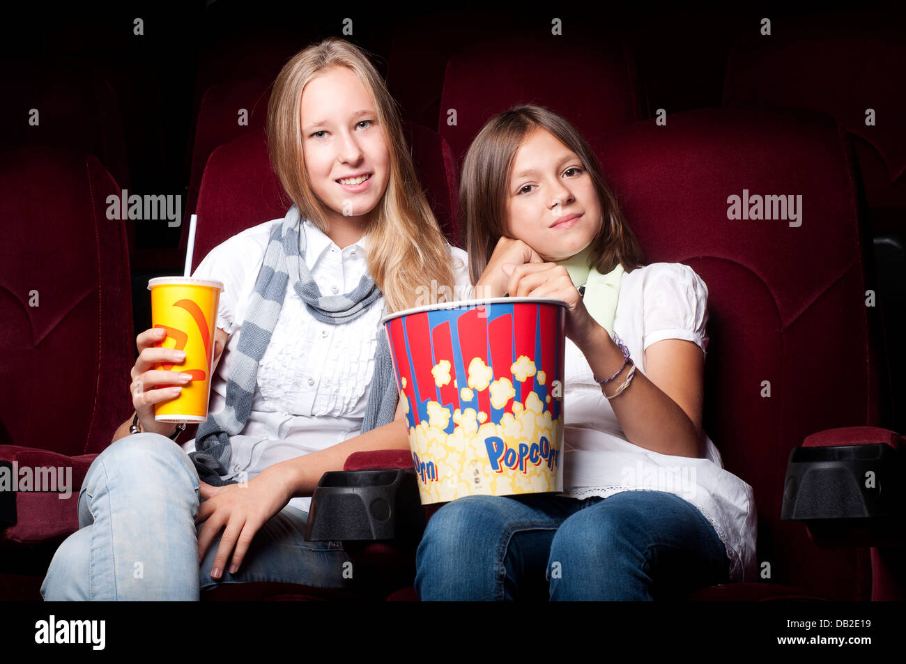two beautiful girls watching a movie at the cinema Stock Photo - Alamy