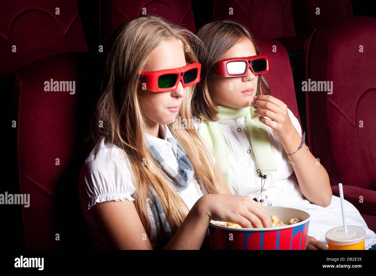 two beautiful girls watching a movie at the cinema Stock Photo - Alamy