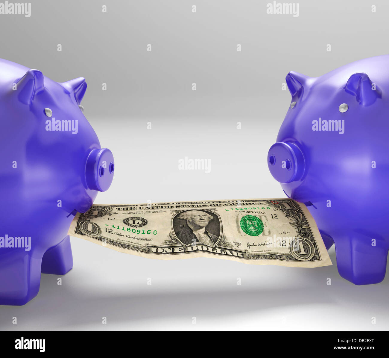 Piggybanks Eating Money Showing Financial Counselling Stock Photo - Alamy