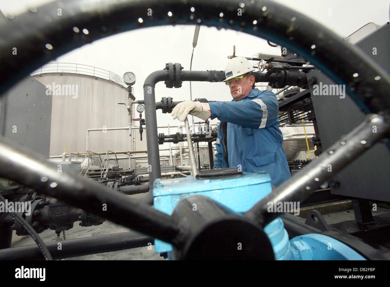 An employee of Wintershall operates a pump at the crude oil plant near ...
