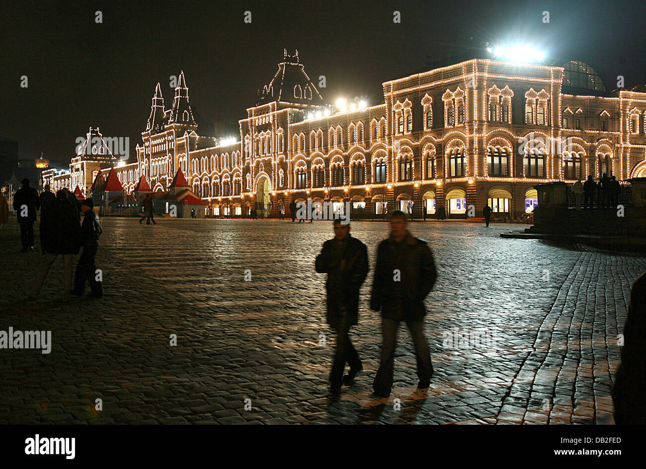 The picture shows the GUM department store, illuminated by chains of ...