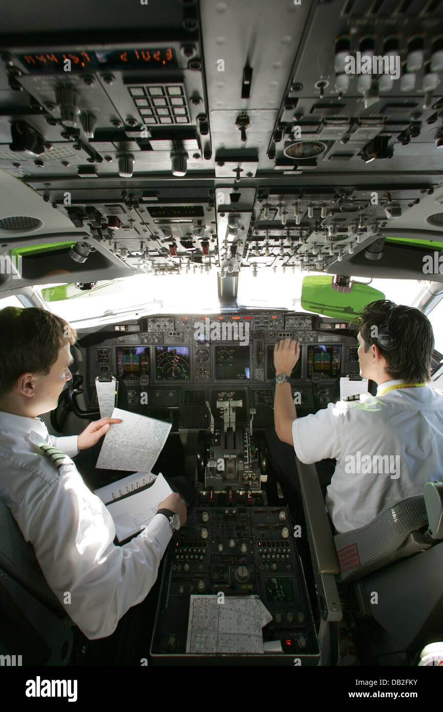Pilot and co-pilot sit in the cockpit of a Boeing 737-800 on a flight ...