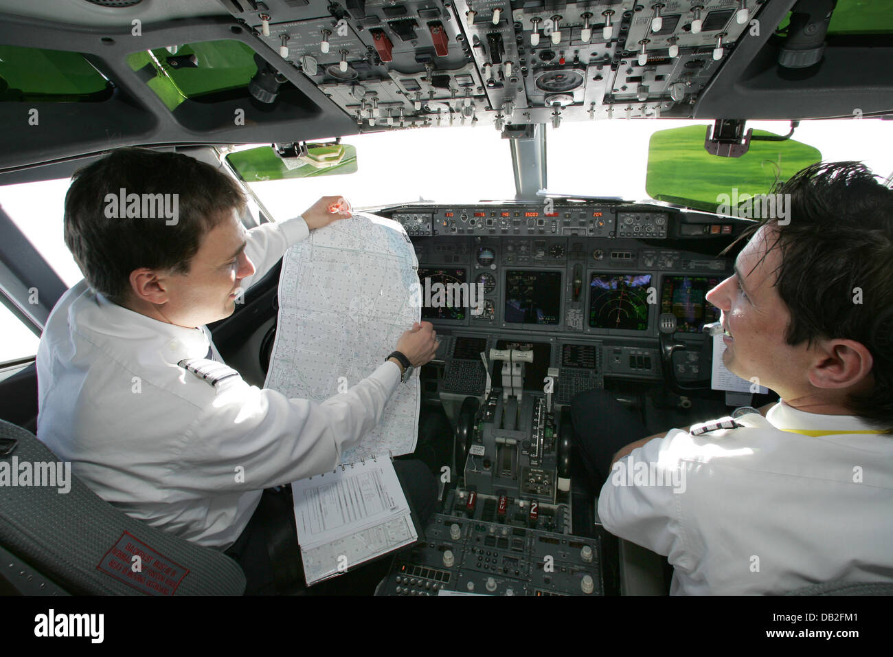Pilot and co-pilot sit in the cockpit of a Boeing 737-800 on a flight ...