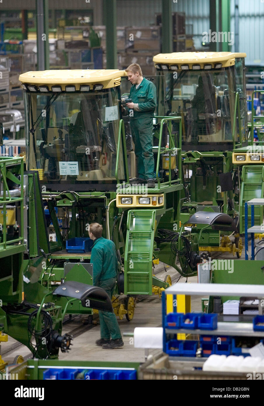 Two workers assemble 'Big M' tractors at a plant of the machine ...