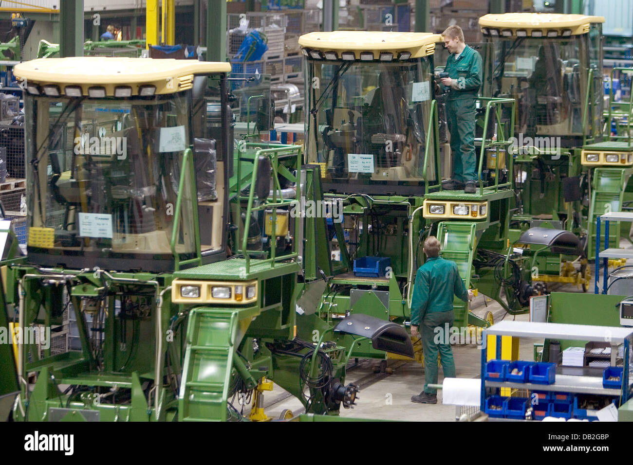 Two workers assemble 'Big M' tractors at a plant of the machine ...
