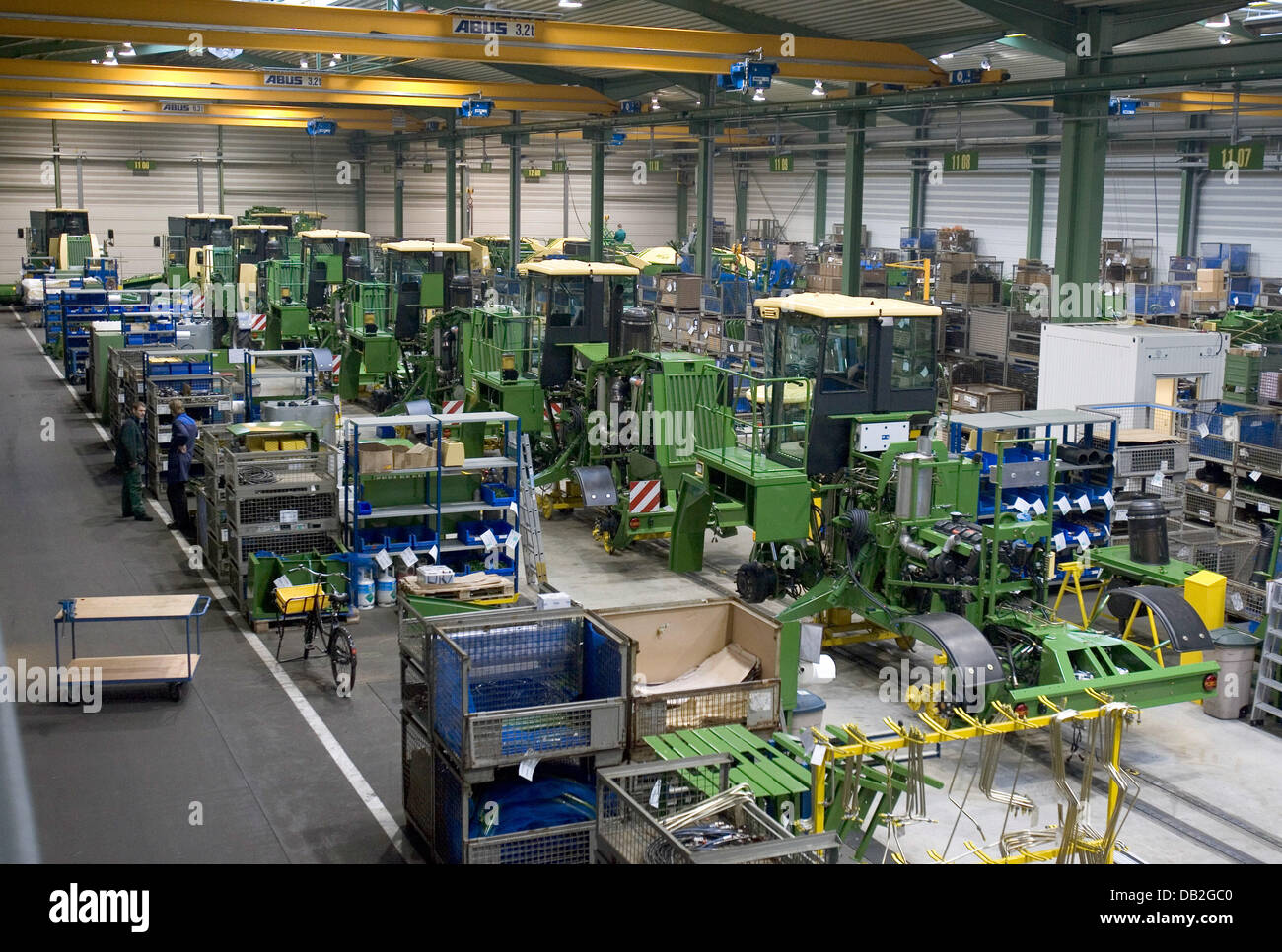 Two workers assemble 'Big M' tractors at a plant of the machine ...