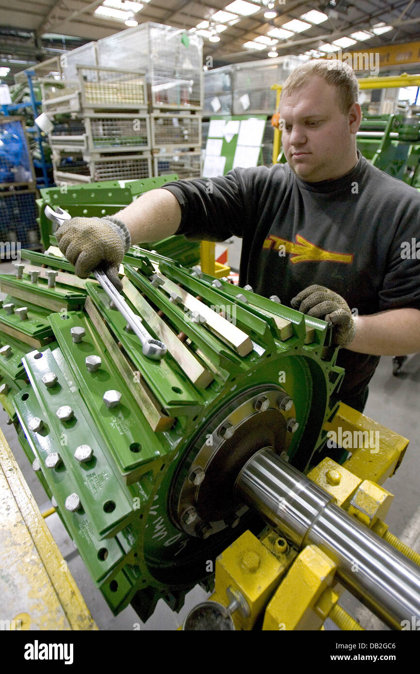 A worker assembles an crop chopper drum at a plant of the land machine ...
