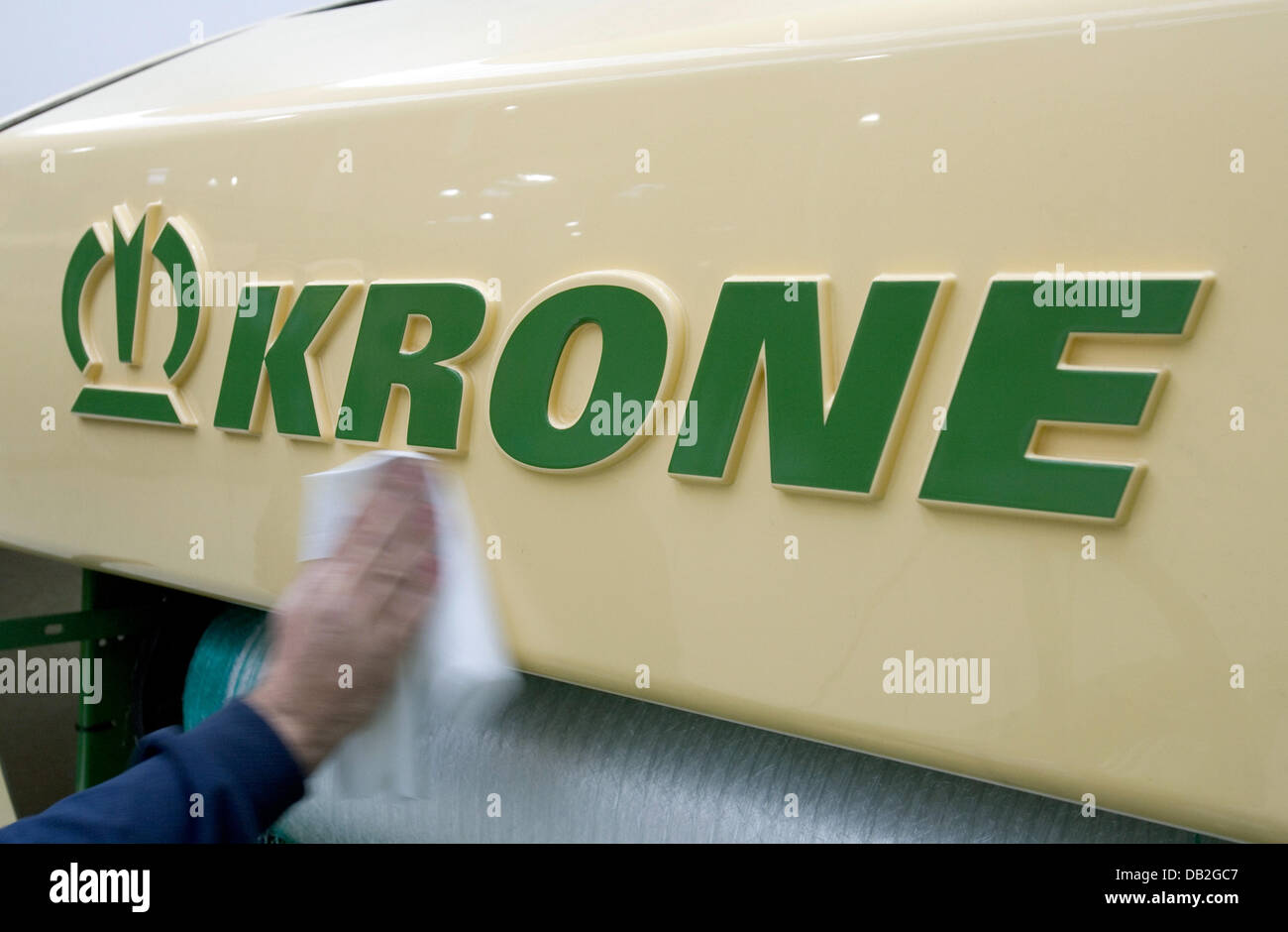 A worker polishes the company's logo assembles at a plant of the land ...