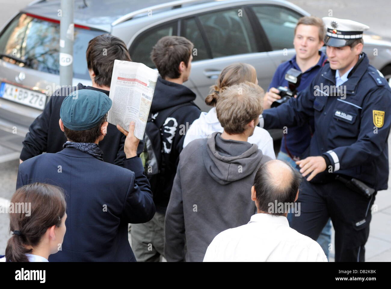 Hidden behind a newspaper, Christian Klar (L), former member of the ...