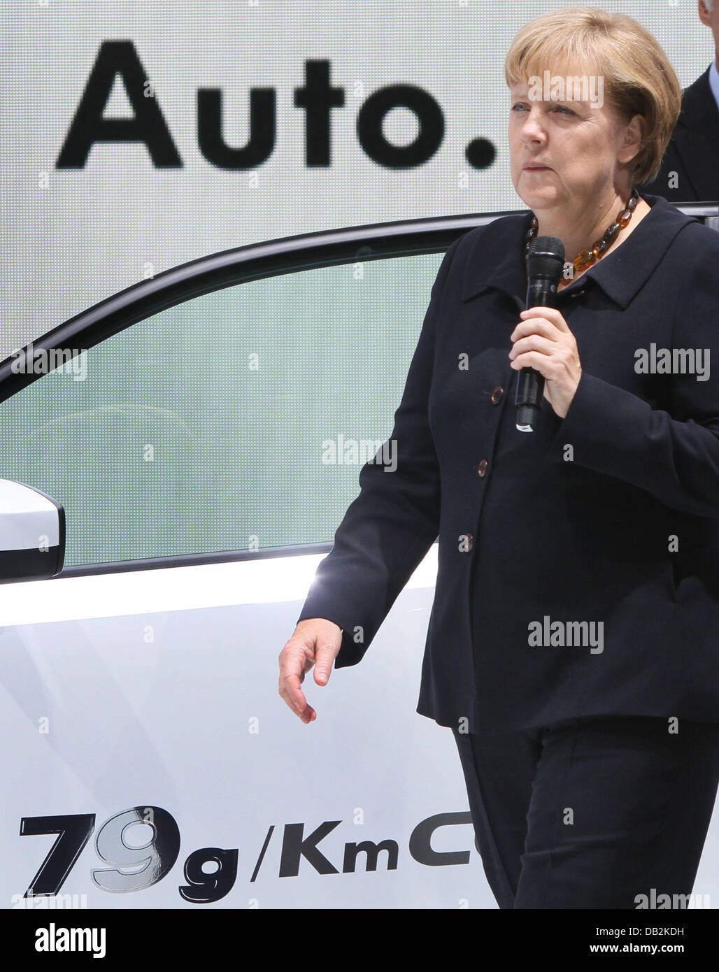 German Chancellor Angela Merkel stands in front of a Multimedi wall ...