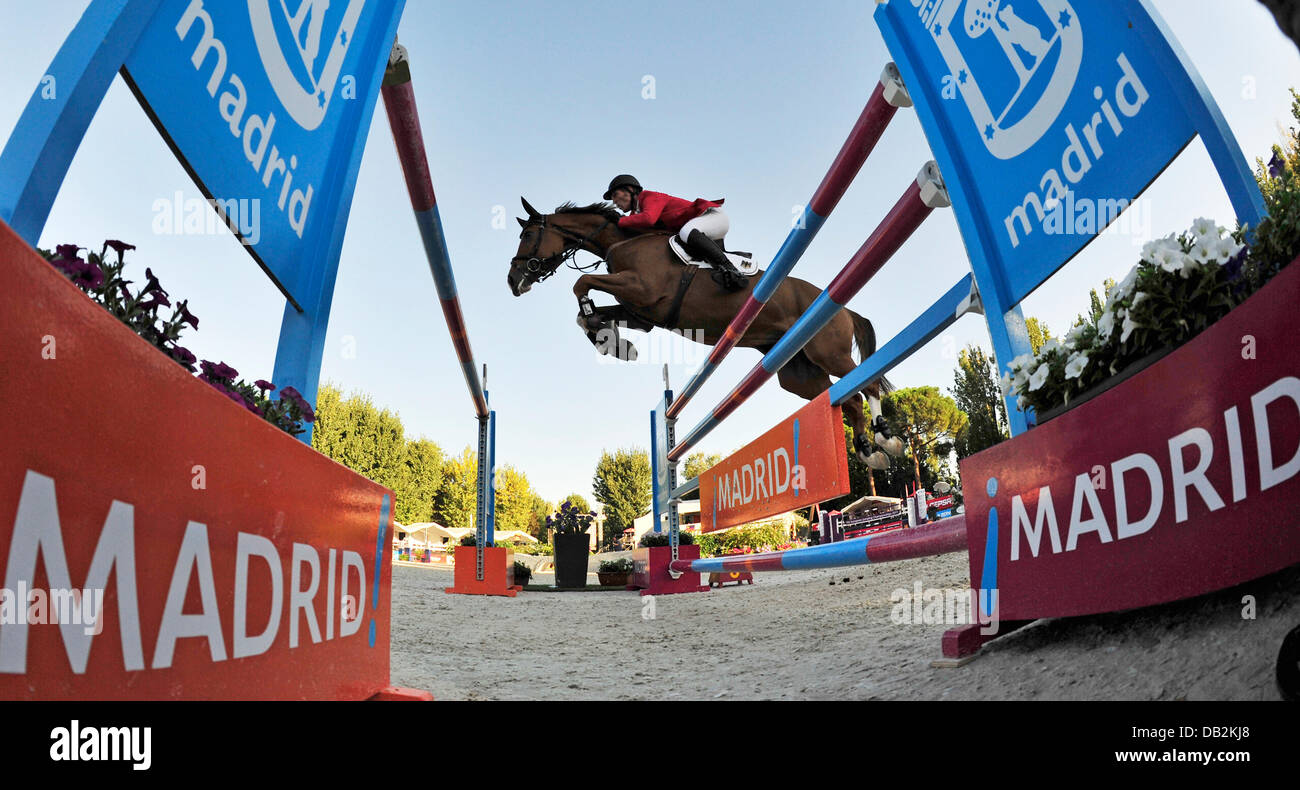 German show jumper Ludger Beerbaum jumps over an obstacle on his horse ...