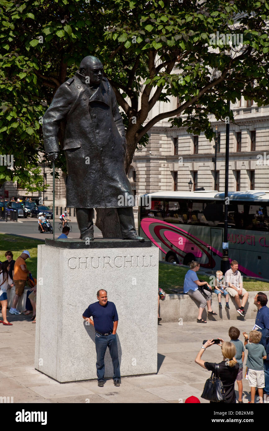 Tourists Pose In Front The Winston Churchill Statue, Parliament Square ...