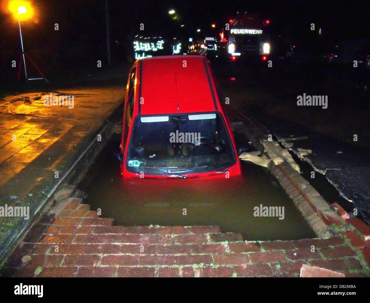 A parked compact car sank into the ground after a pipe burst in the ...