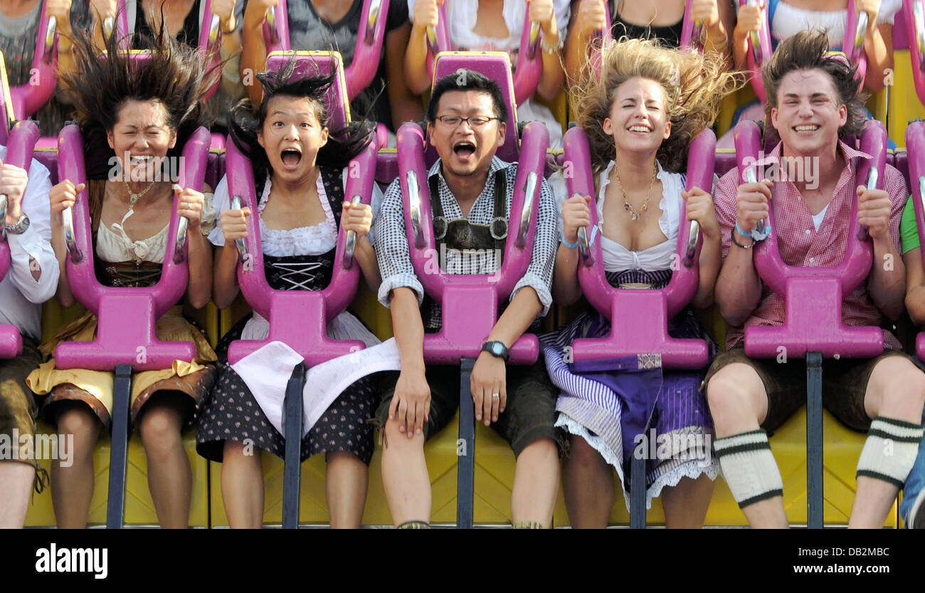 Visitors ride a carnival ride at Oktoberfest on the Theresienwiese in ...