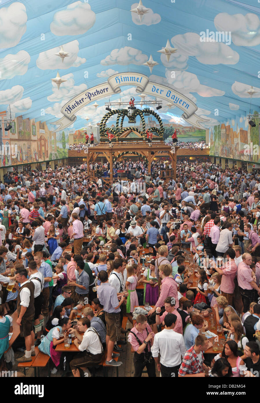 Visitors sit in a beer ten under the slogan "heaven of Bavaria" at ...