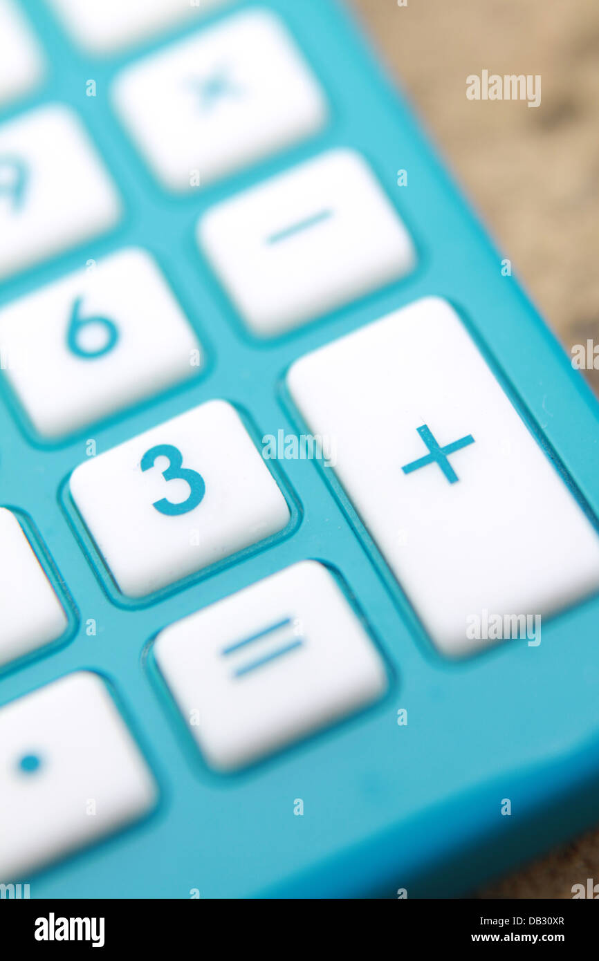 detail of the number 3 and the addition button on a child's calculator ...