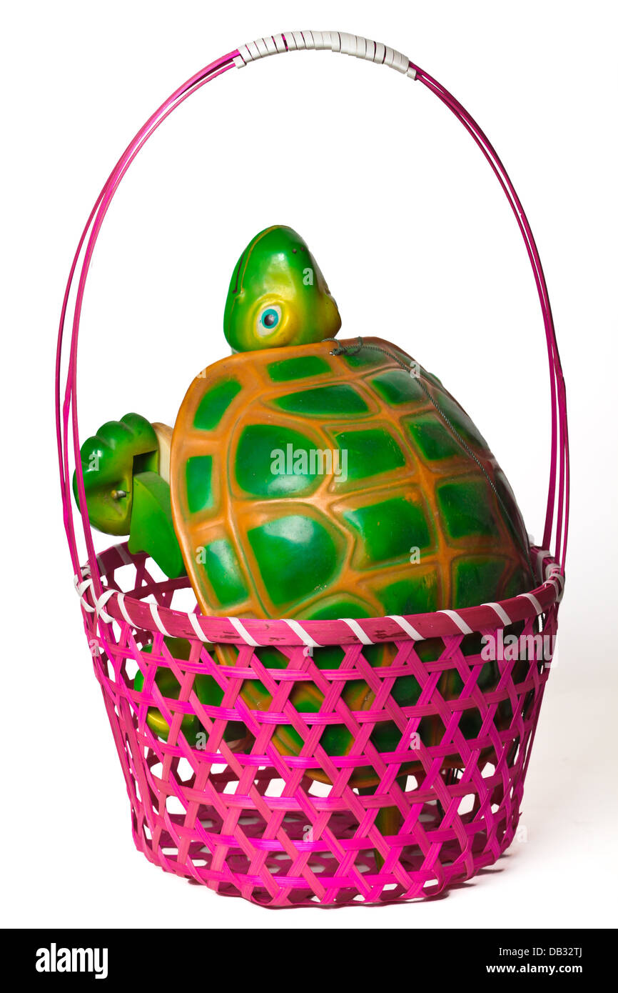 Toy turtle in a colorful bamboo basket Stock Photo - Alamy